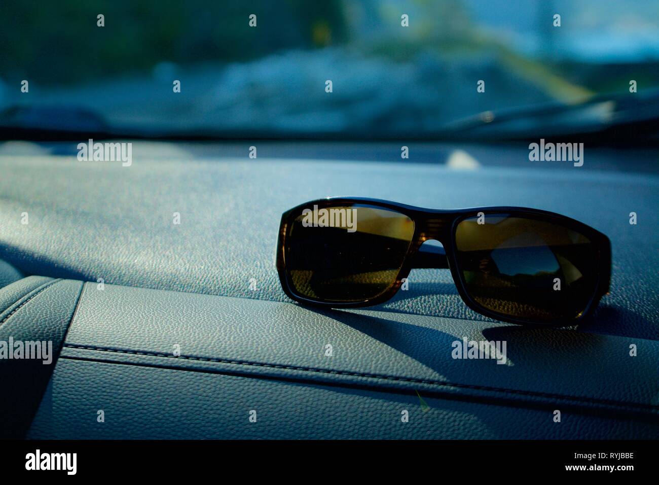 Sunglasses on a car Dash Stock Photo - Alamy