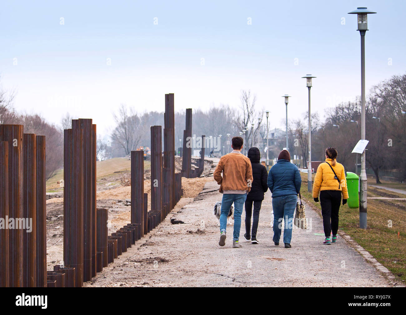 People walking on the flood protection dam during the construction work ...