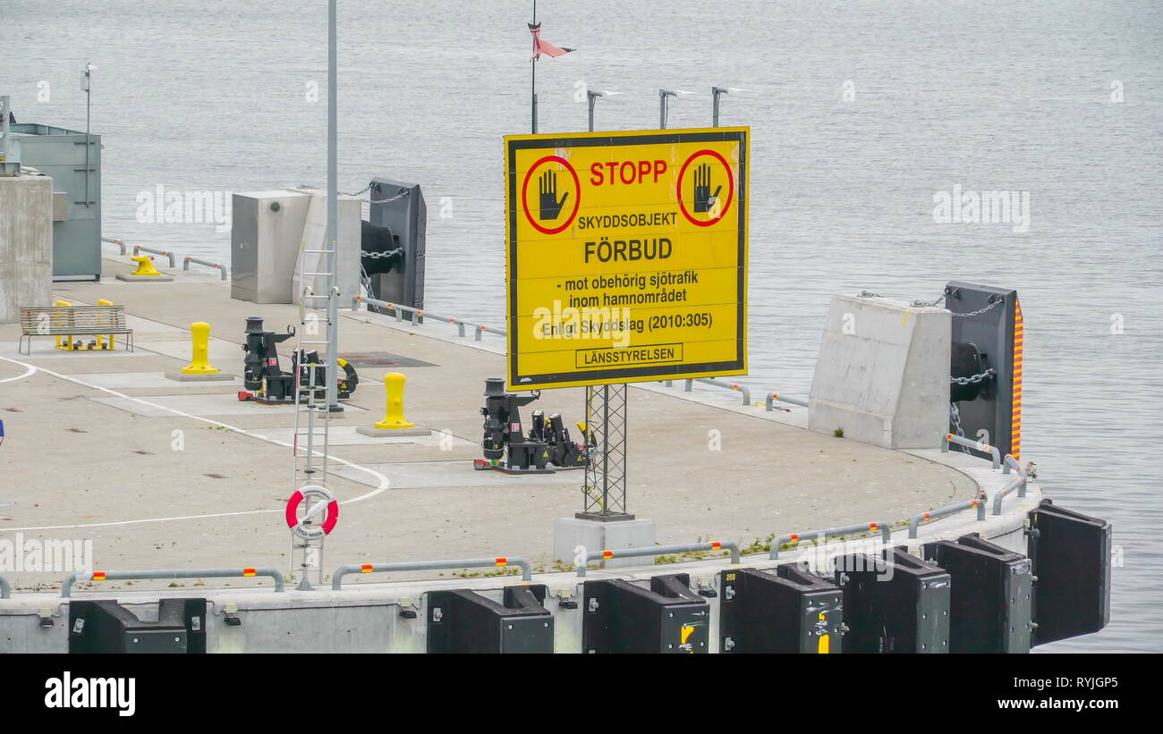 The big STOP signage on the side of the harbor port where the ship is ...
