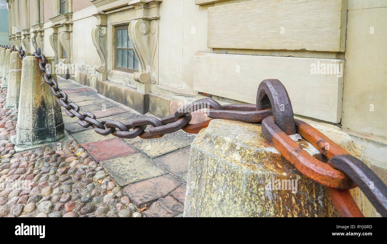 A rusty chain lined outside the palace in Stockholm Sweden with the ...