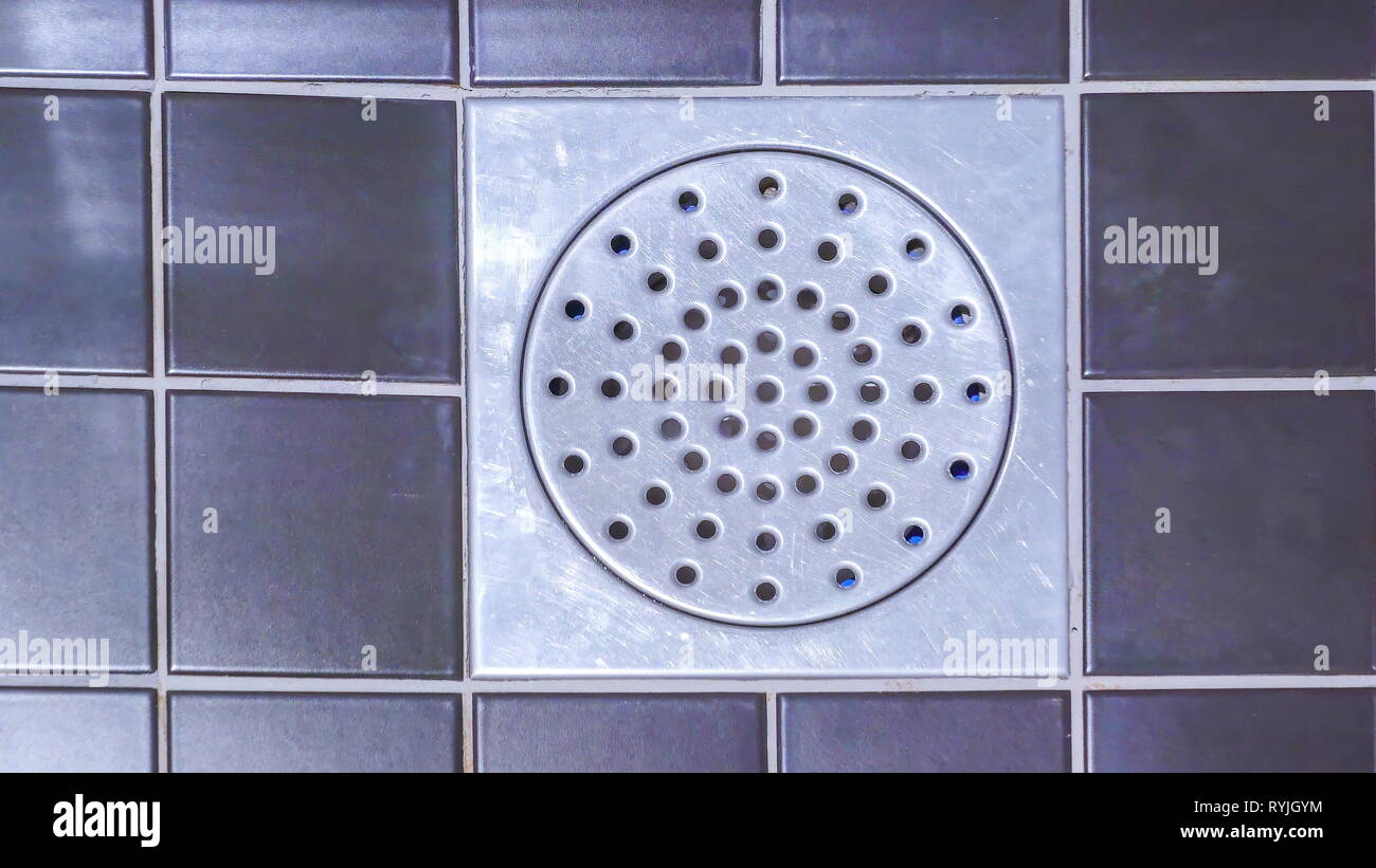 The drainage hole on the floor of the bathroom with the color blue ...