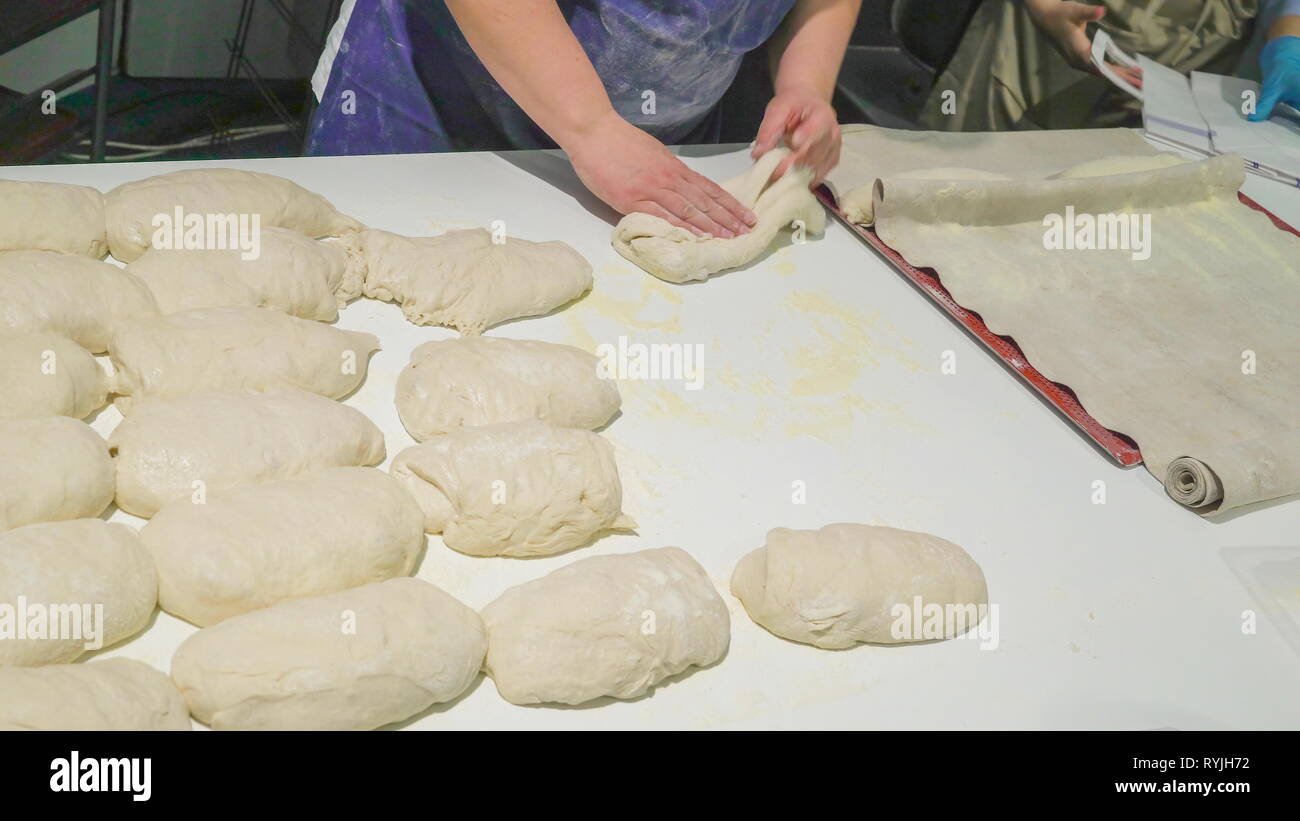 The process of kneading the bread dough on the table to make the dough ...