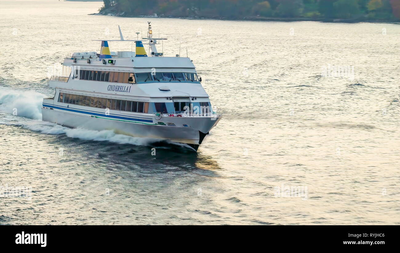 A white small ship travelling on the sea water with the view of the ...