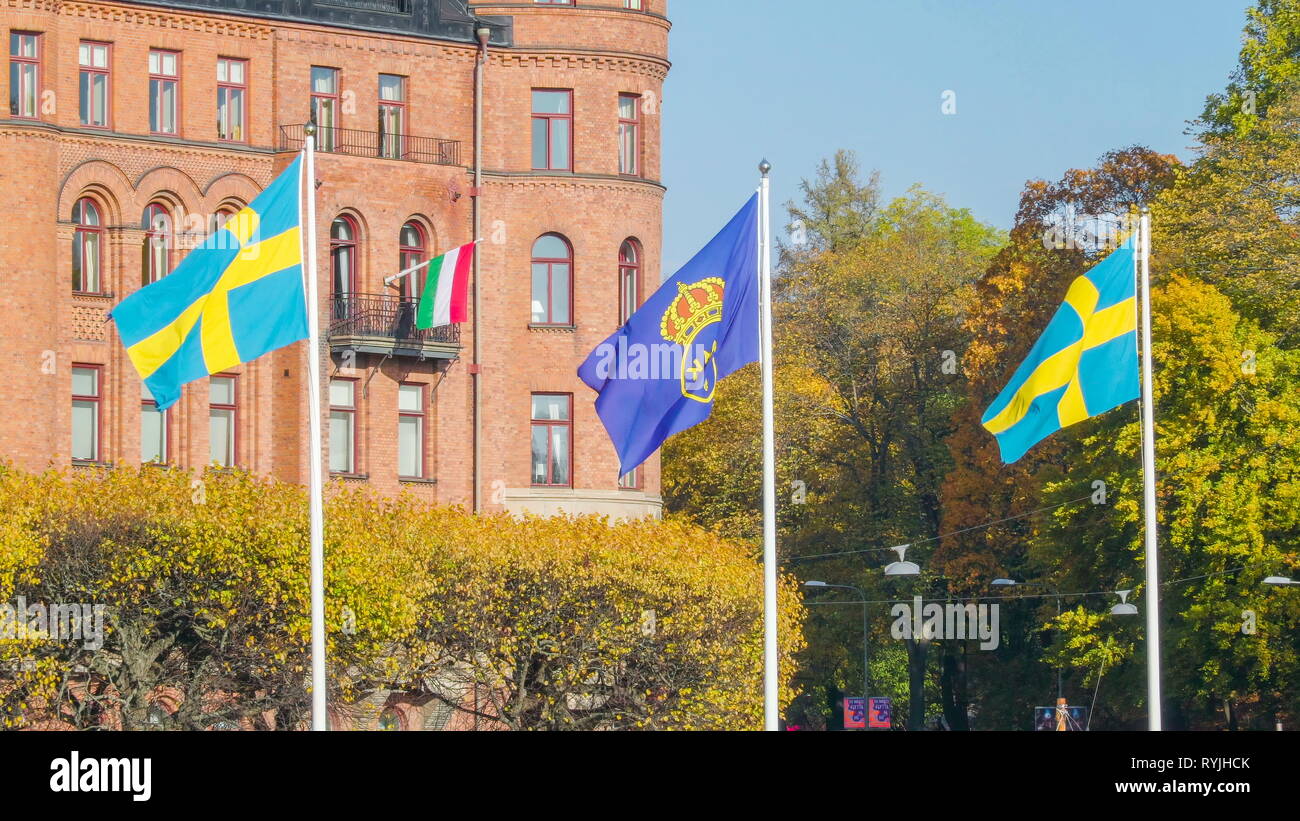 Two flags of Sweden waving on the pole in Stockholm with the blue flag ...
