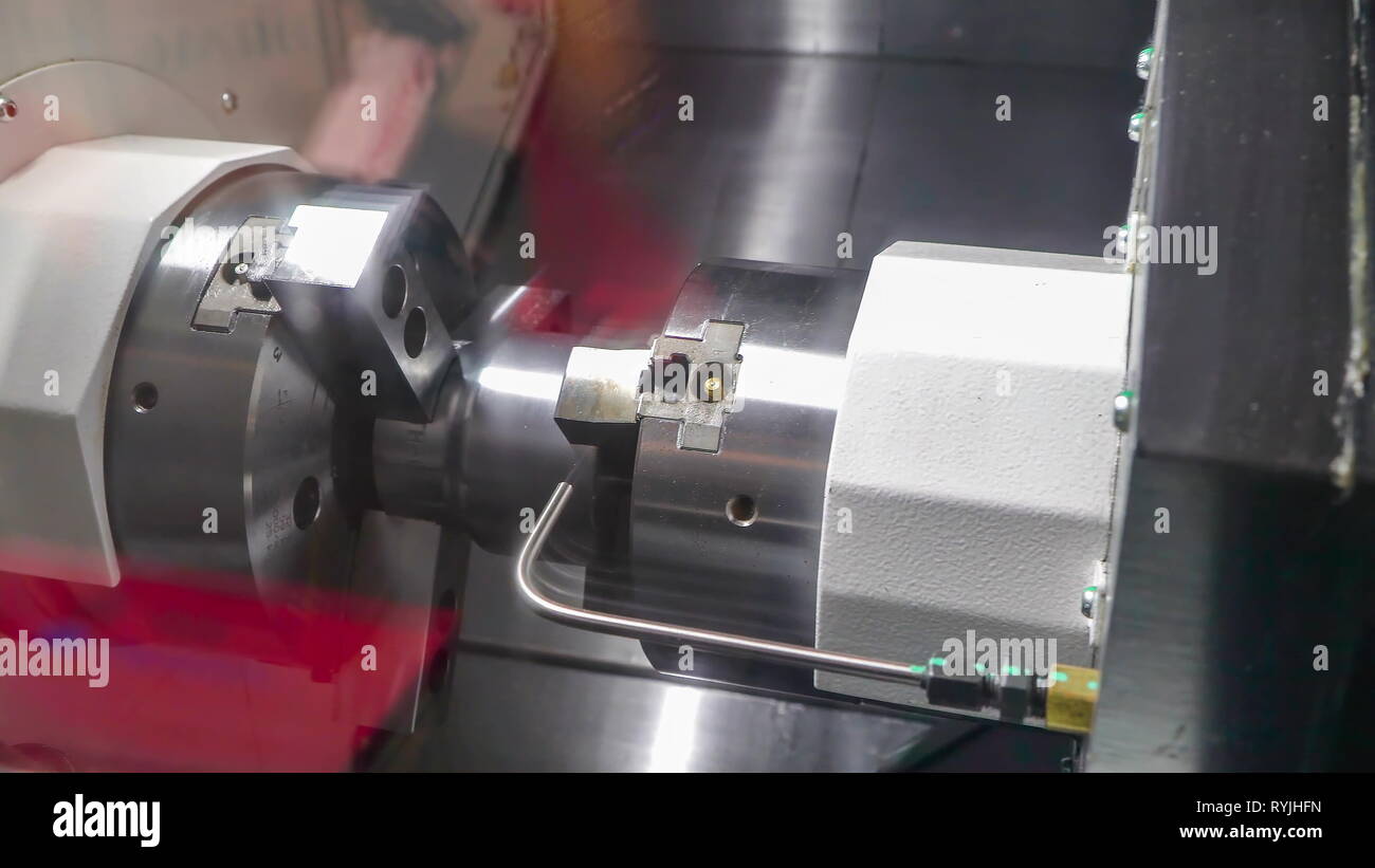 Closer look of the cnc machine with the turning part of the metal steel ...