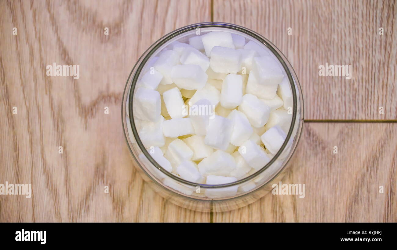 Sugar cubes inside the glass jar in the kitchen with the open lid of ...