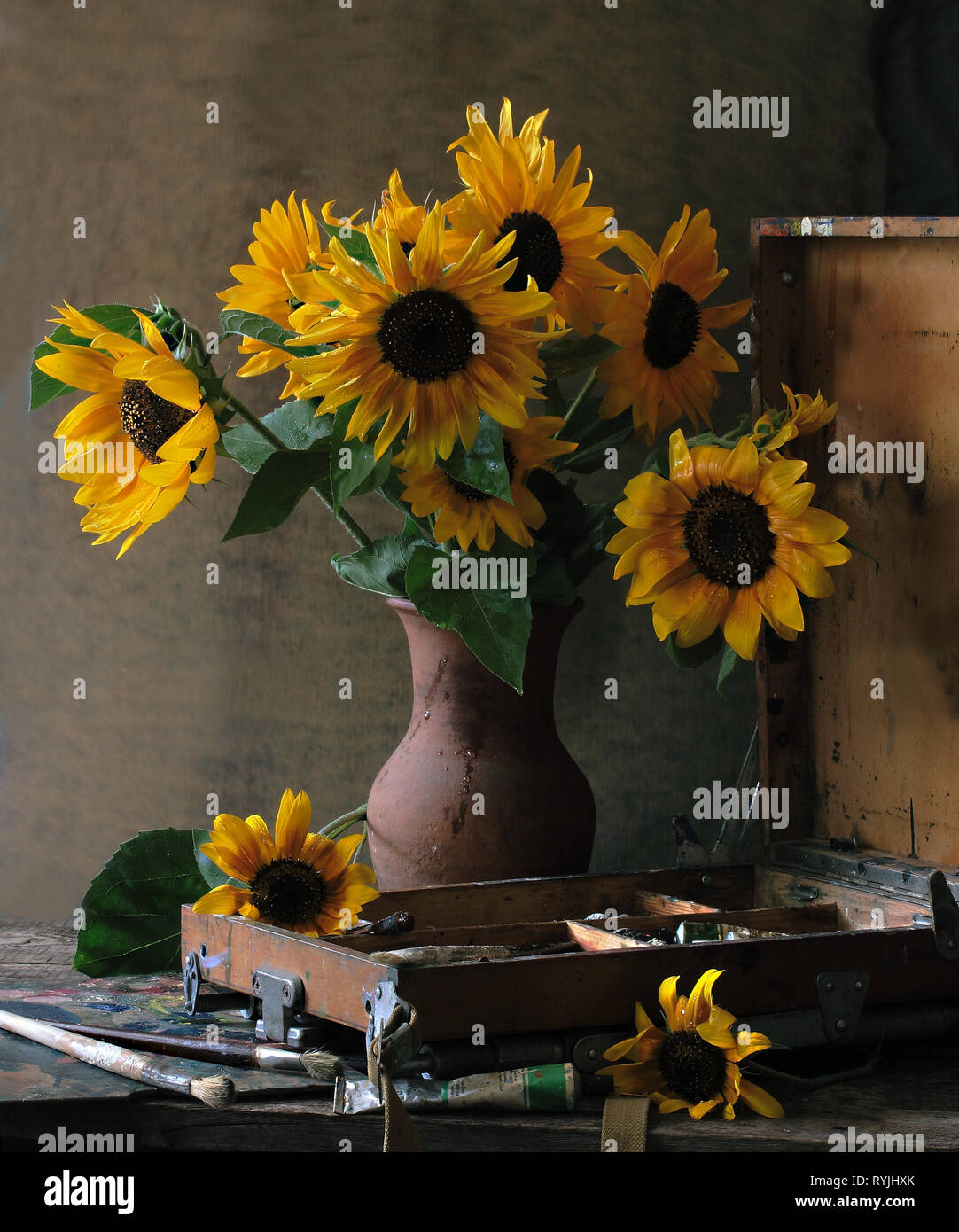 Still life with sunflowers and paints Stock Photo - Alamy