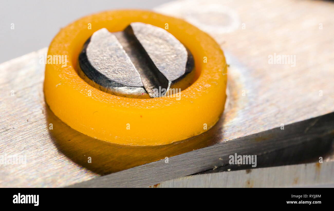 Sharp and shiny shears of the scissors on a macro shot with the orange ...