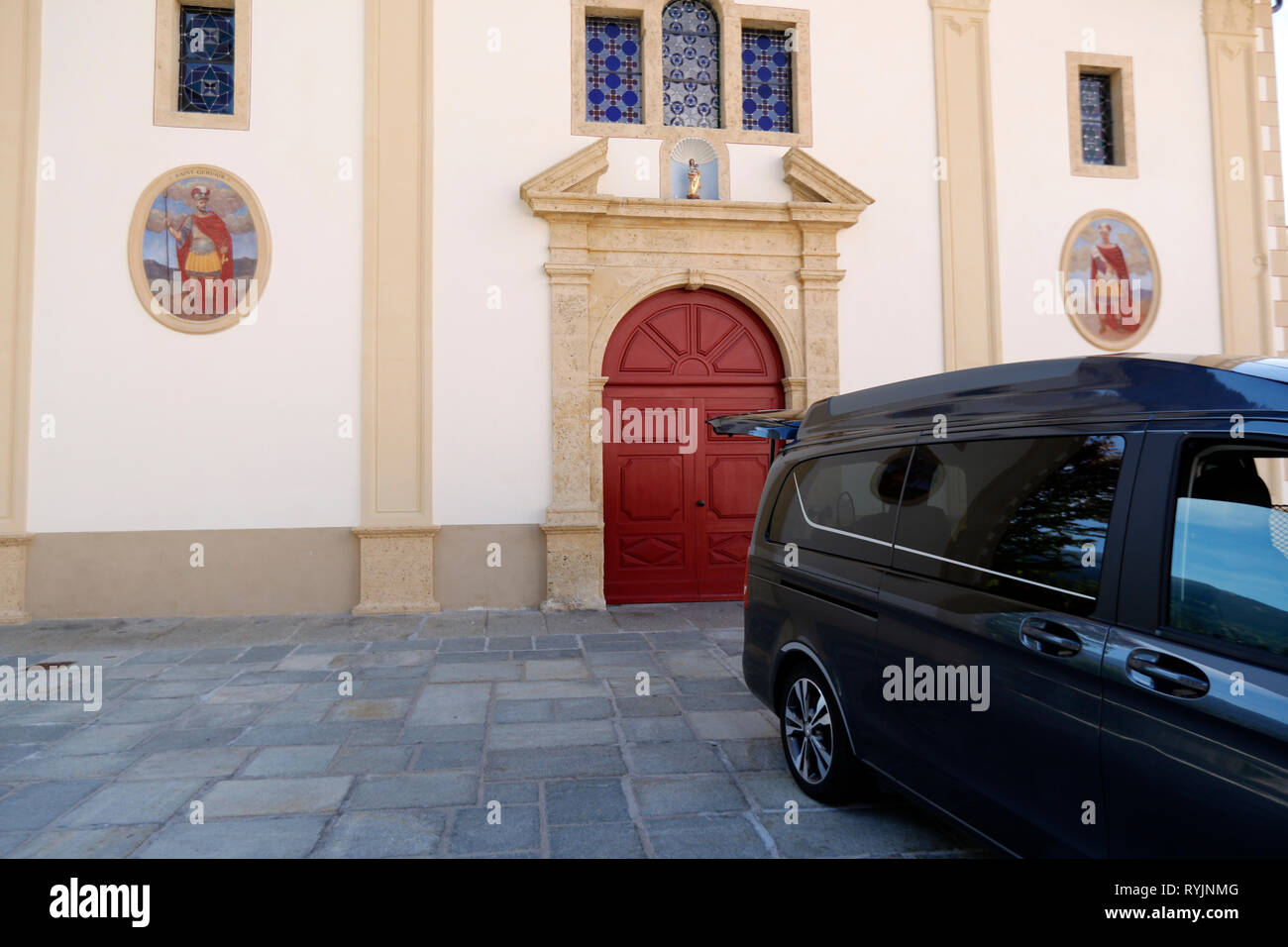 Funeral service. Mercedes hearse in front a church Stock Photo - Alamy
