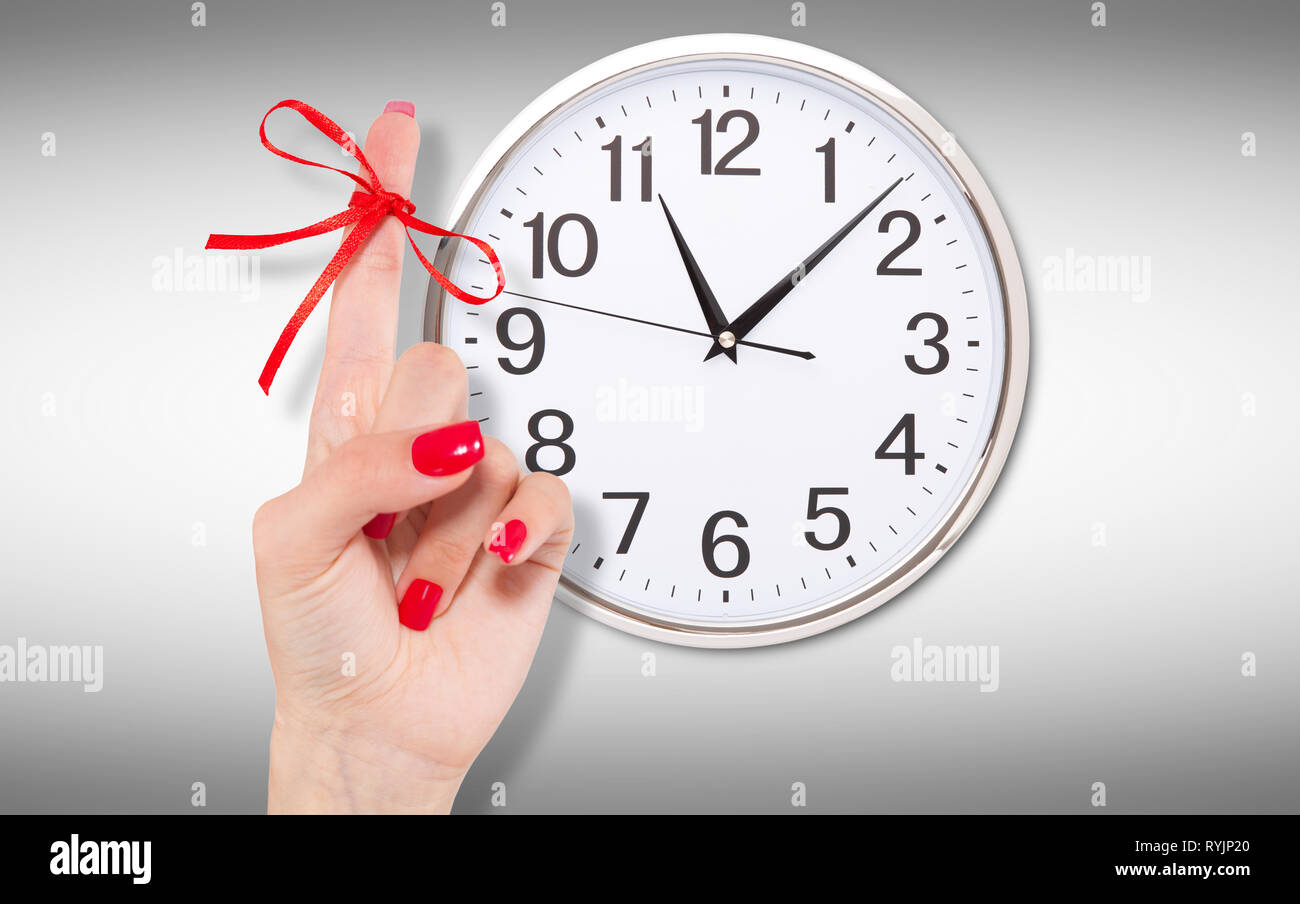Red bow on finger and clock isolated on white background Stock Photo ...