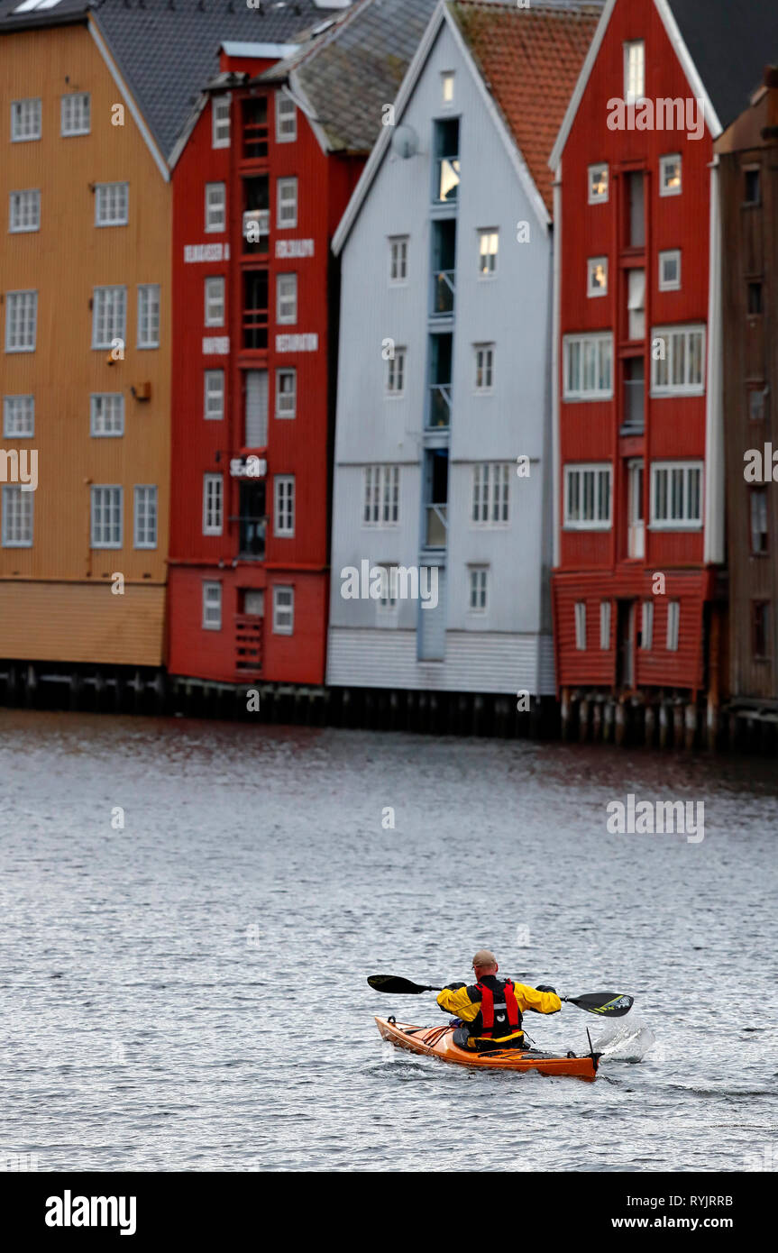 Restored and converted storehouses along the River Nidelva. River ...