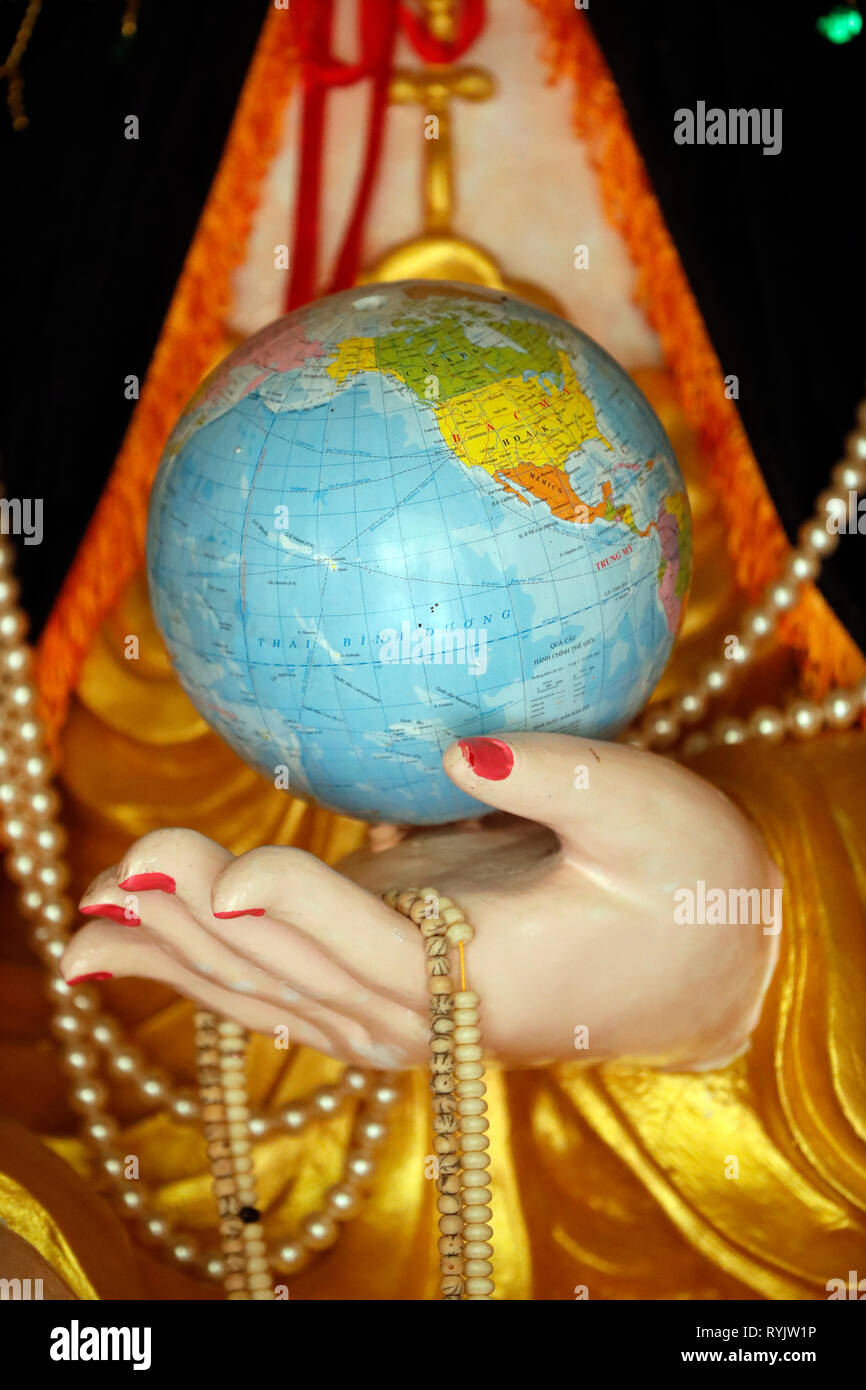 Buddhist pagoda. Statue. Buddhist hand holding earth. Can Tho. Vietnam ...