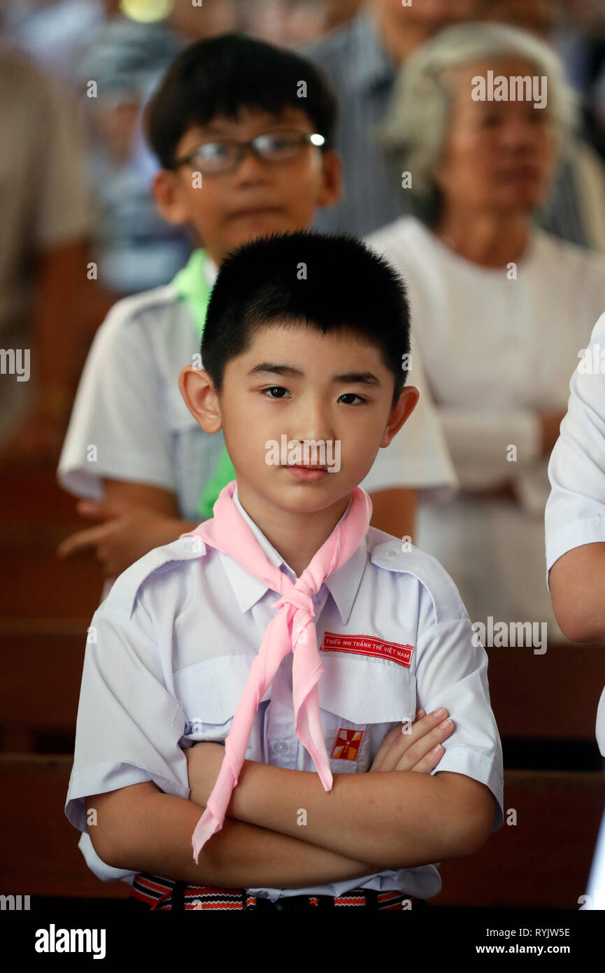 Christian children at sunday morning catholic mass. Chau Doc church ...