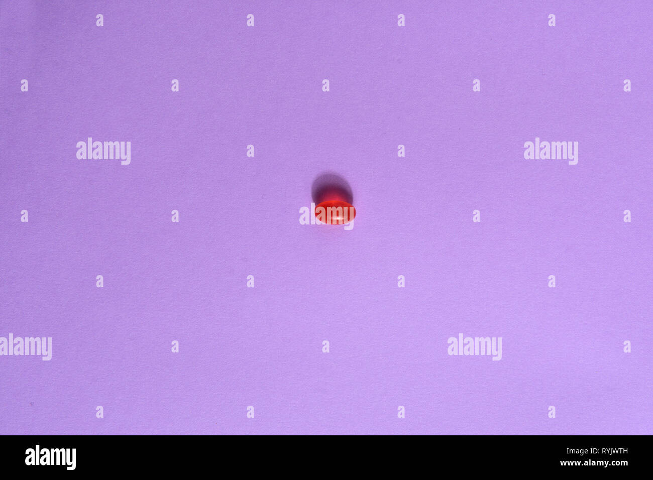 gelatin capsule pill on violet Stock Photo - Alamy