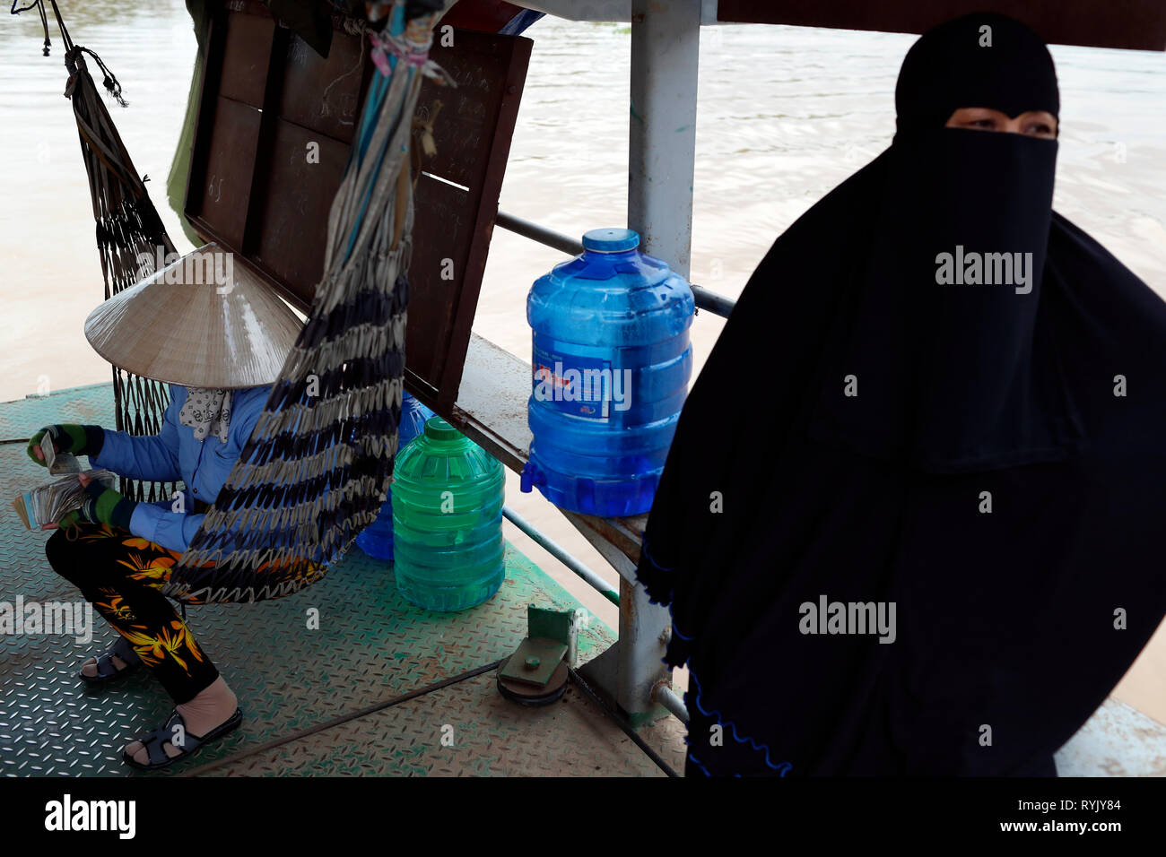 Muslim woman wearing the hijab and Vietnamese woman wearing the ...