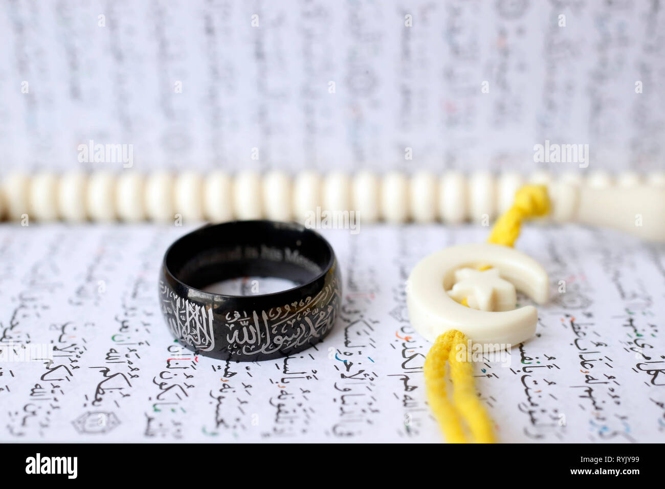 Quran, islamic ring and Tasbih (prayer beads). Muslim symbols. Close-up ...