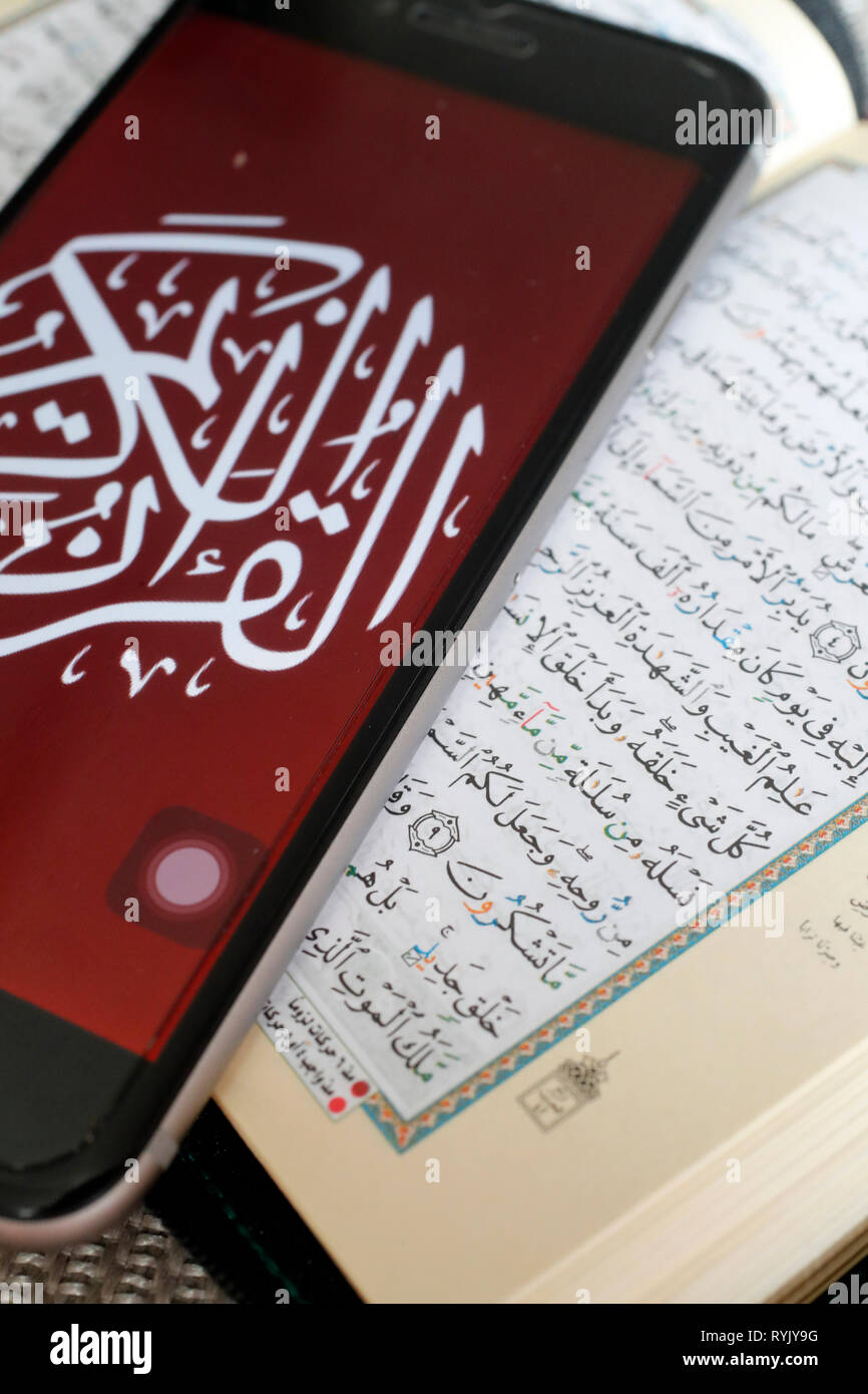 Digital quran on a smartphone and Holy Quran book. Close-up Stock Photo ...