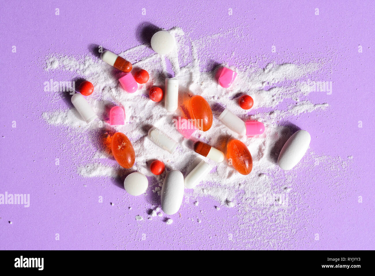 capsules pills broken with your powder medication on violet background ...