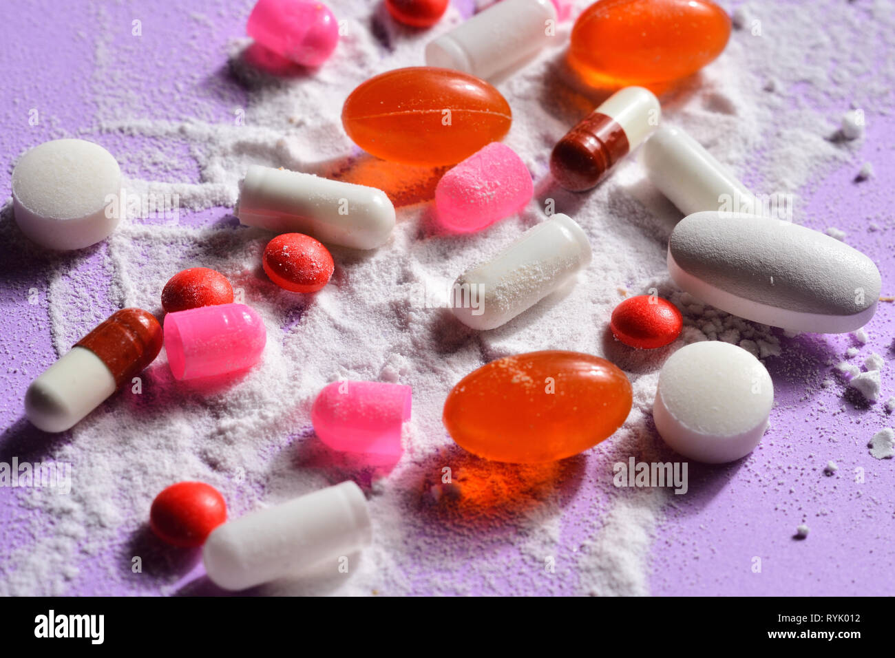 capsules pills broken with your powder medication on violet background ...