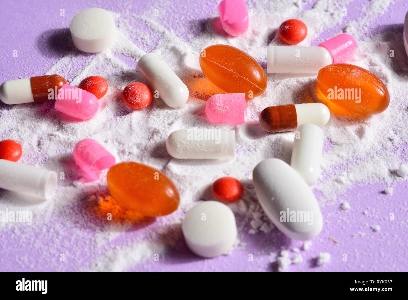 capsules pills broken with your powder medication on violet background ...