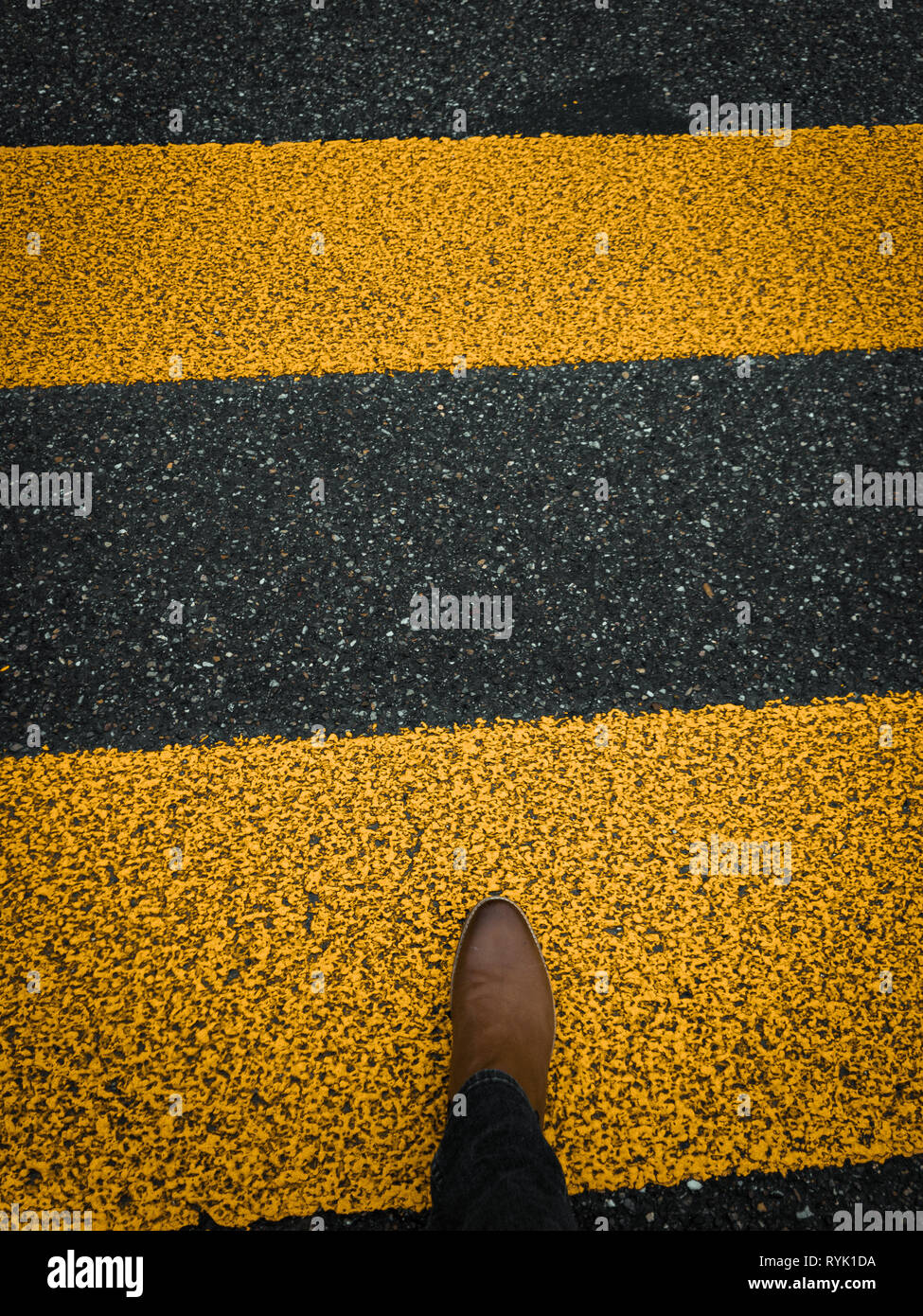pedestrian sign on pavement with brown leather boot Stock Photo - Alamy