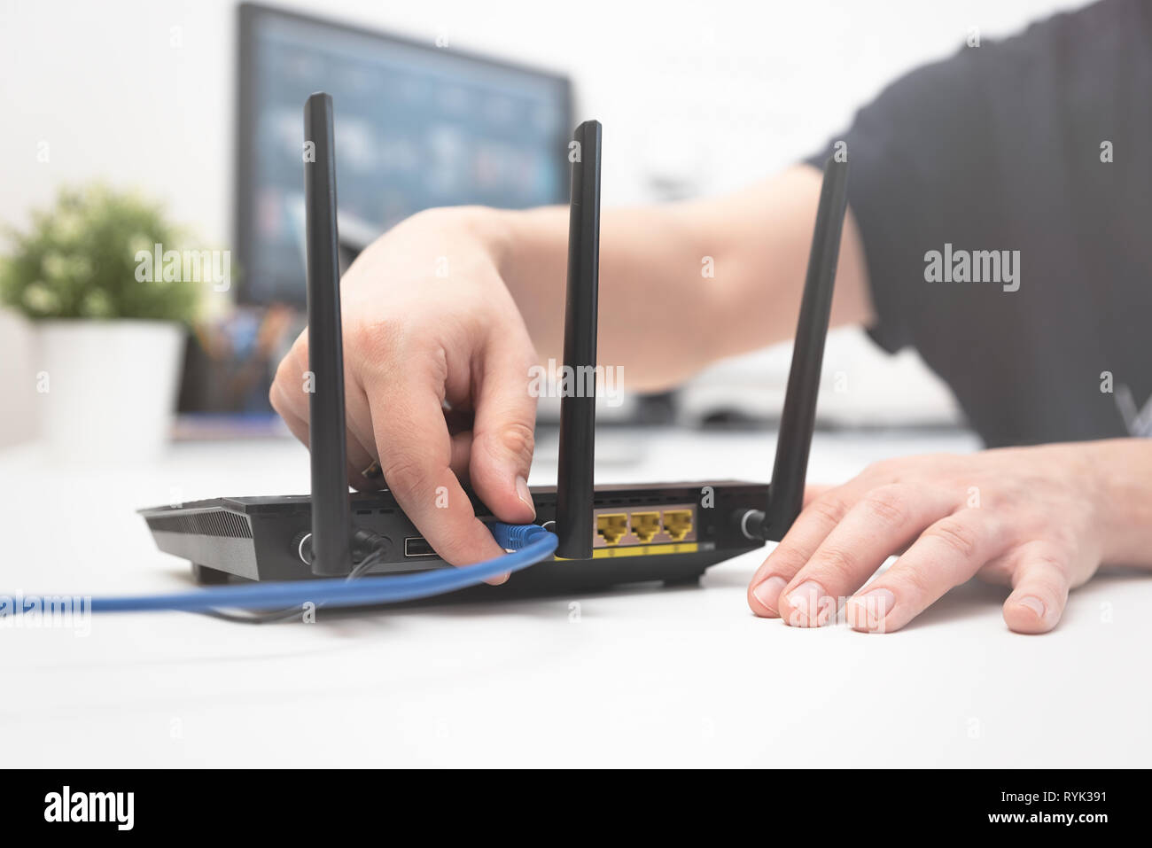Man connects the internet cable to the router's socket. Fast and ...