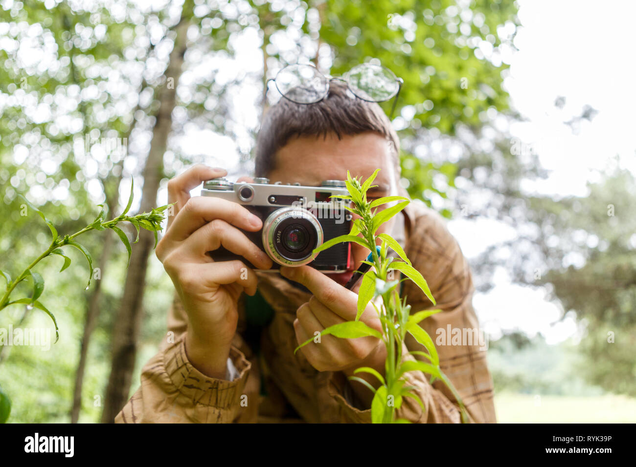 Image of man with camera in woods Stock Photo - Alamy
