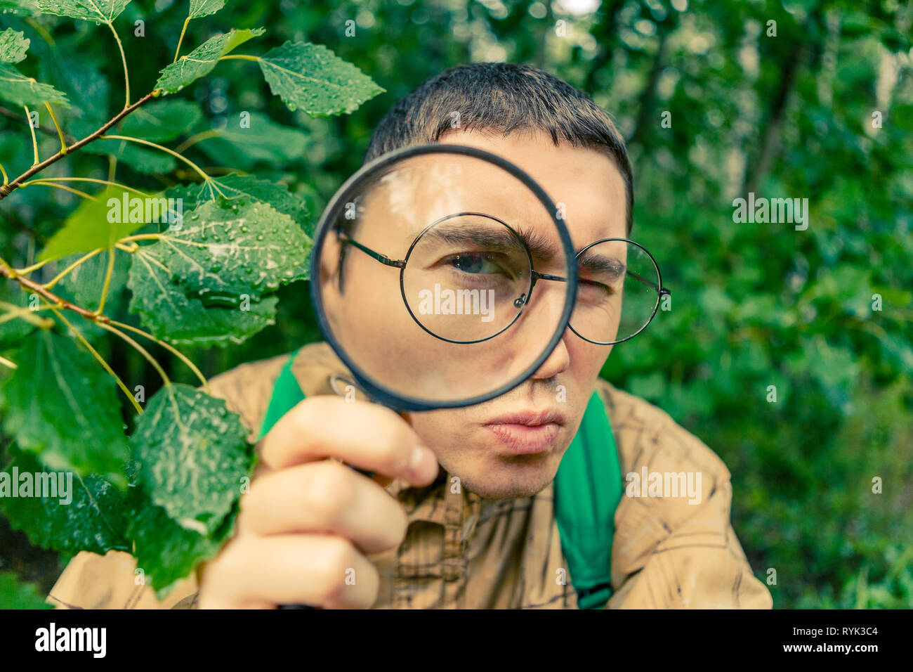Portrait of male botanist with magnifying glass Stock Photo - Alamy