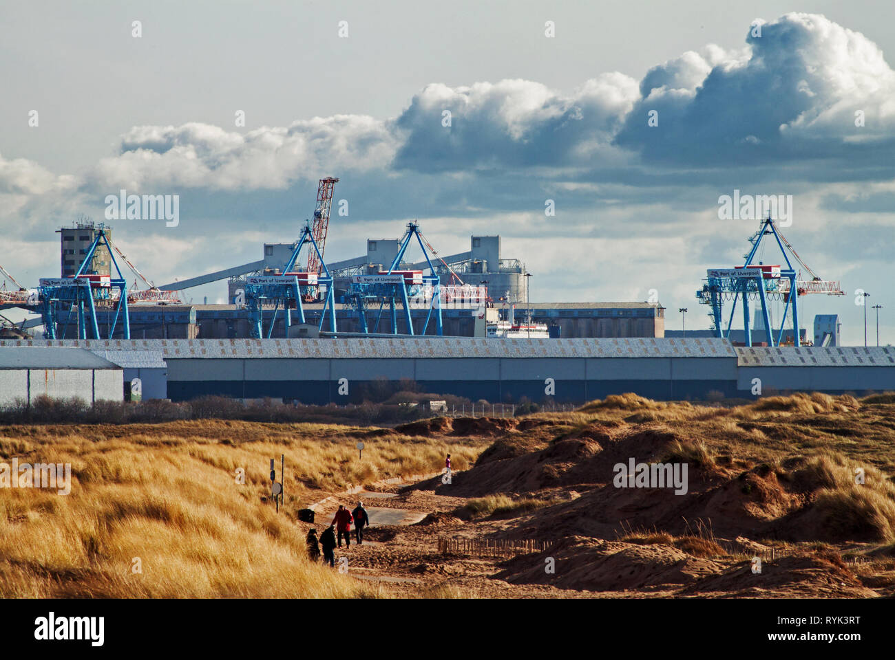 People appear to be walking between Formby and Liverpool, by the sand ...