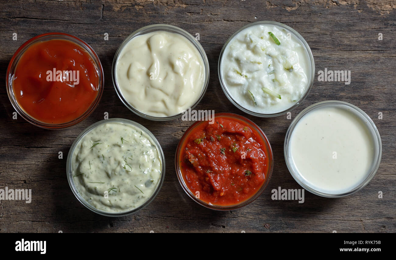 Different delicious sauces for dishes isolated on table Stock Photo - Alamy