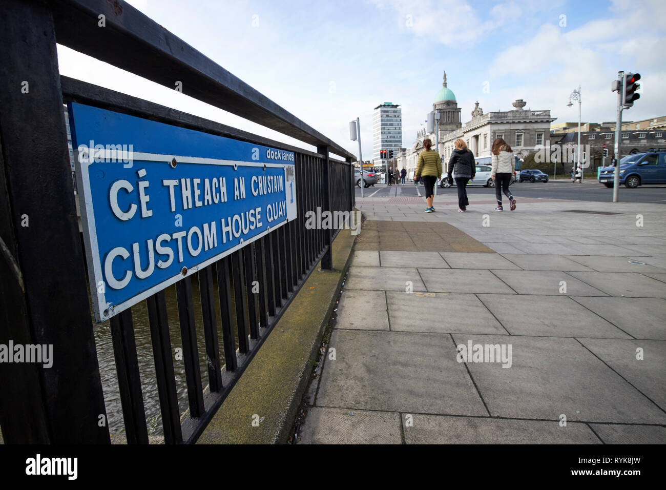 three women walking along custom house quay with a view of the custom ...