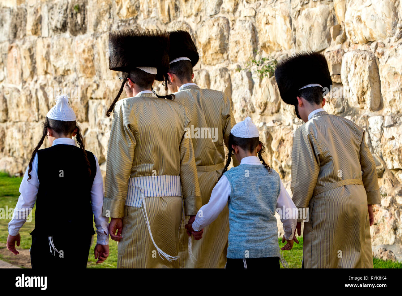 Orthodox jews walking along a wall of Jerusalem old city, Israel Stock ...