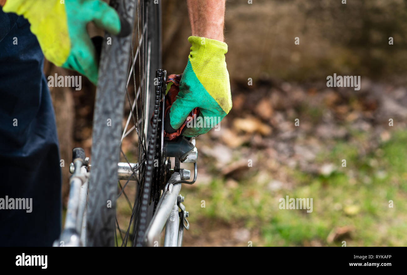 Man cleaning his bicycle for the new driving season Stock Photo - Alamy