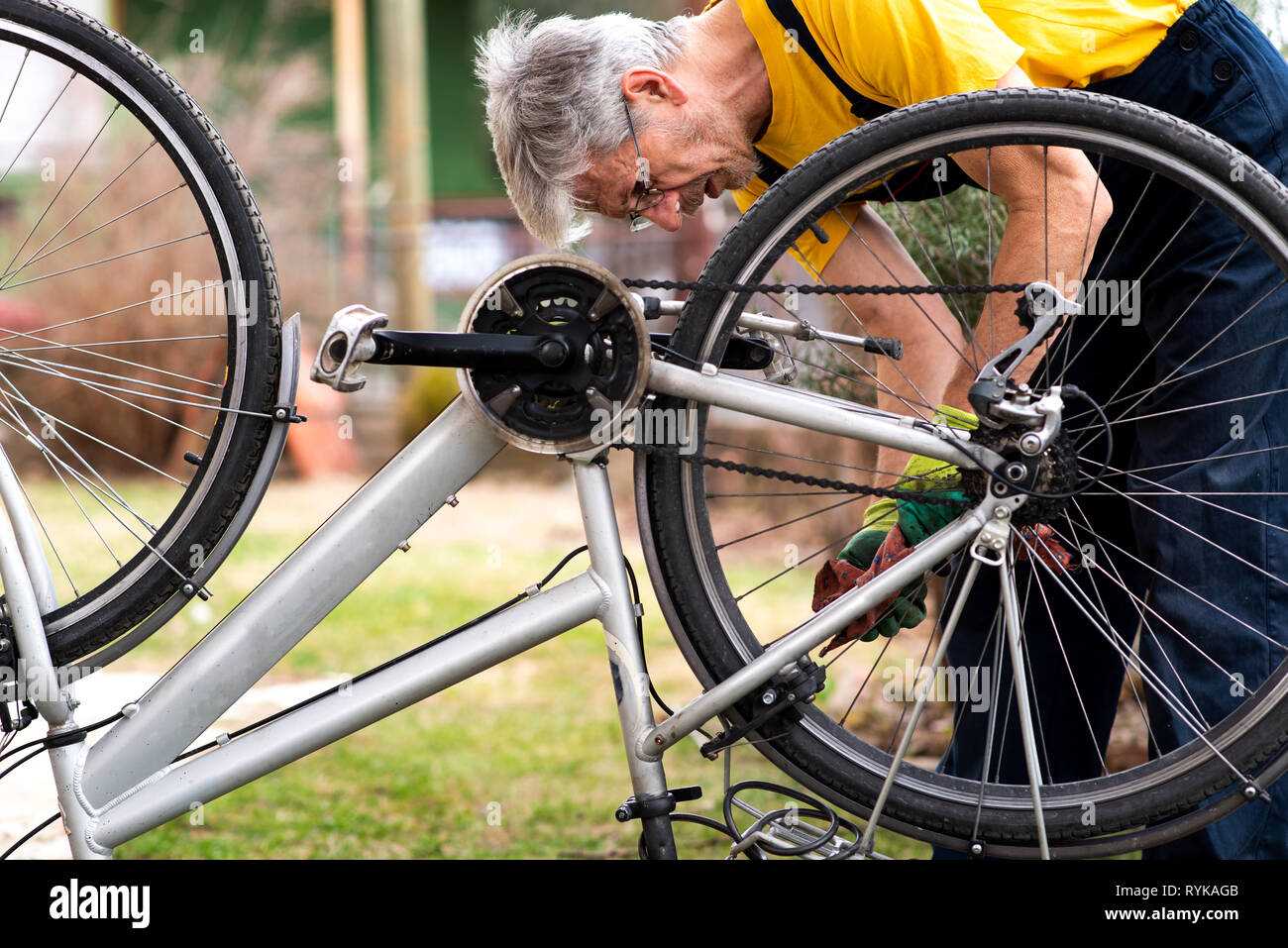 Man maintaining his bicycle for the new driving season Stock Photo - Alamy