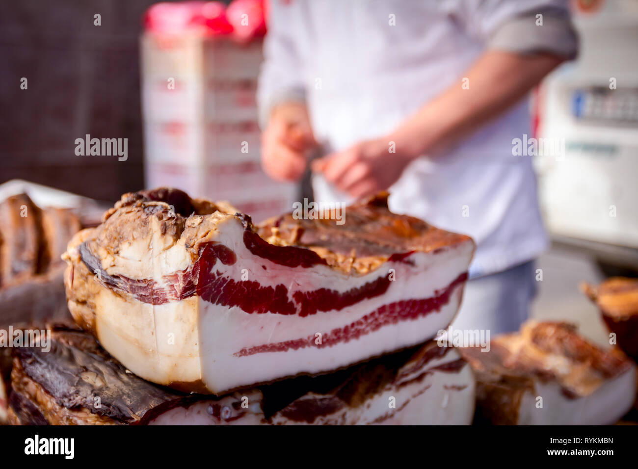 Bunch of cured bacon, meat for sale at outdoor flea market Stock Photo ...