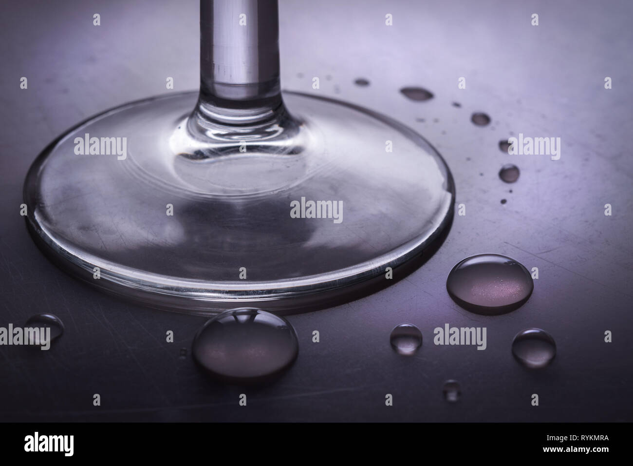 Close-up of an elegant glass beaker with alcoholic drink and water ...