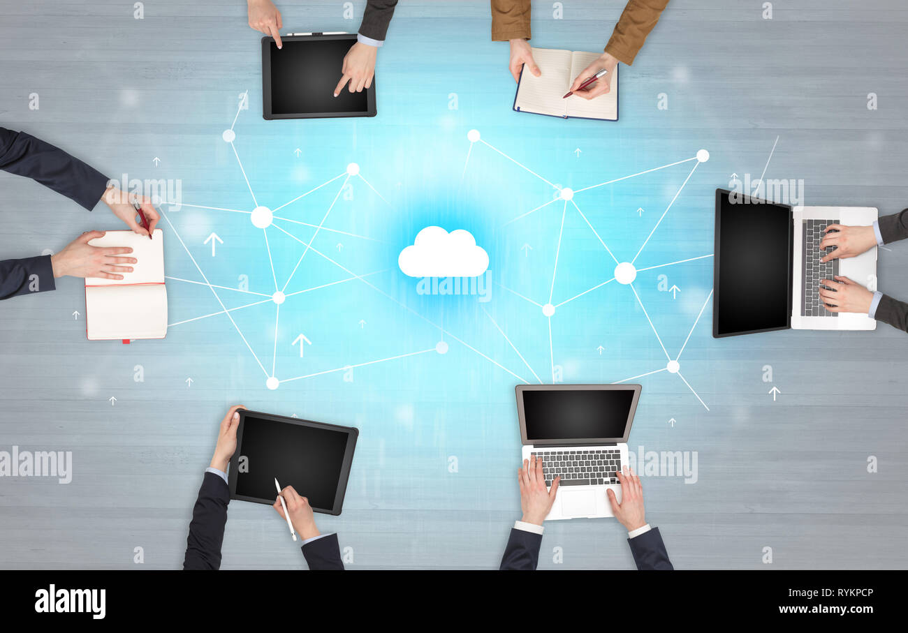 Group of people with devices in hands working in team on tablets ...