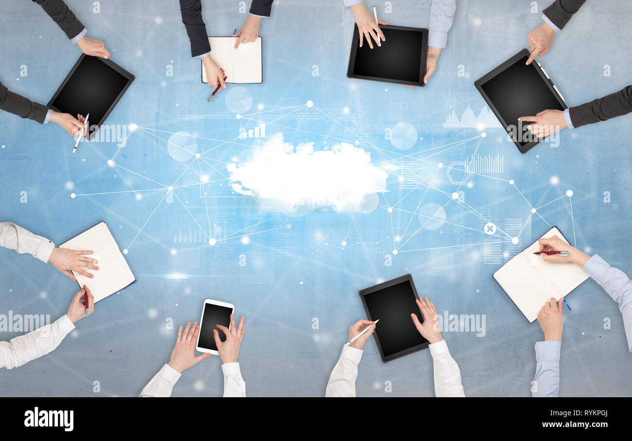 Group of people with devices in hands working on reports with online ...