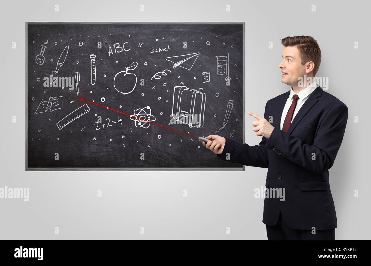 Handsome young teacher with laser pointer teaching Stock Photo - Alamy