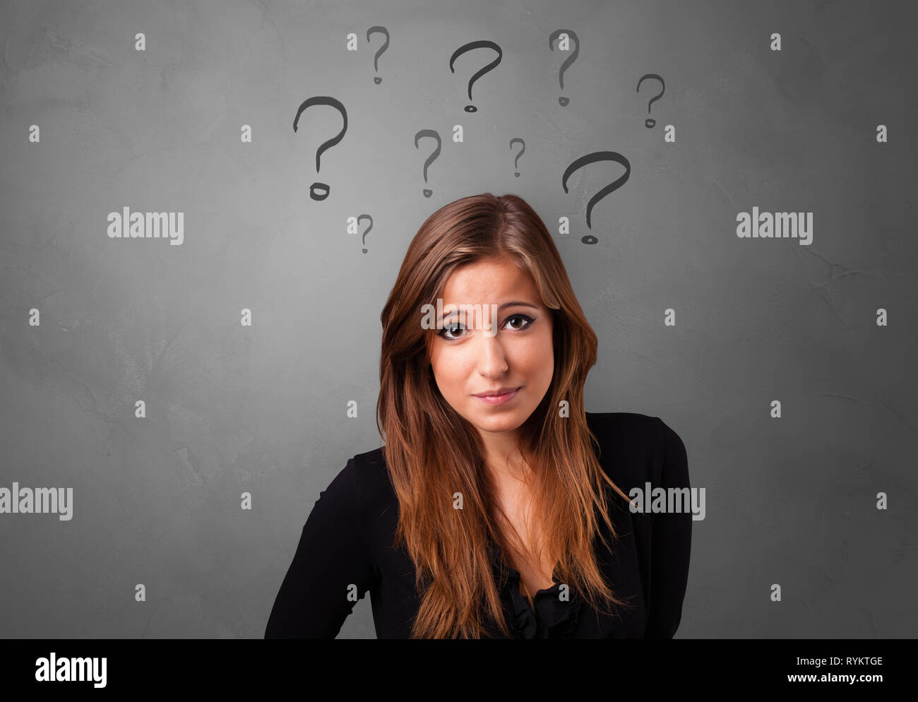 Person with question marks around face Stock Photo - Alamy
