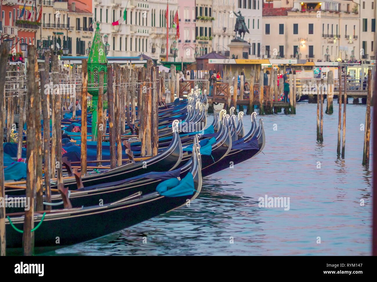 The line of black gondolas floating in the canal in Venice in Italy ...