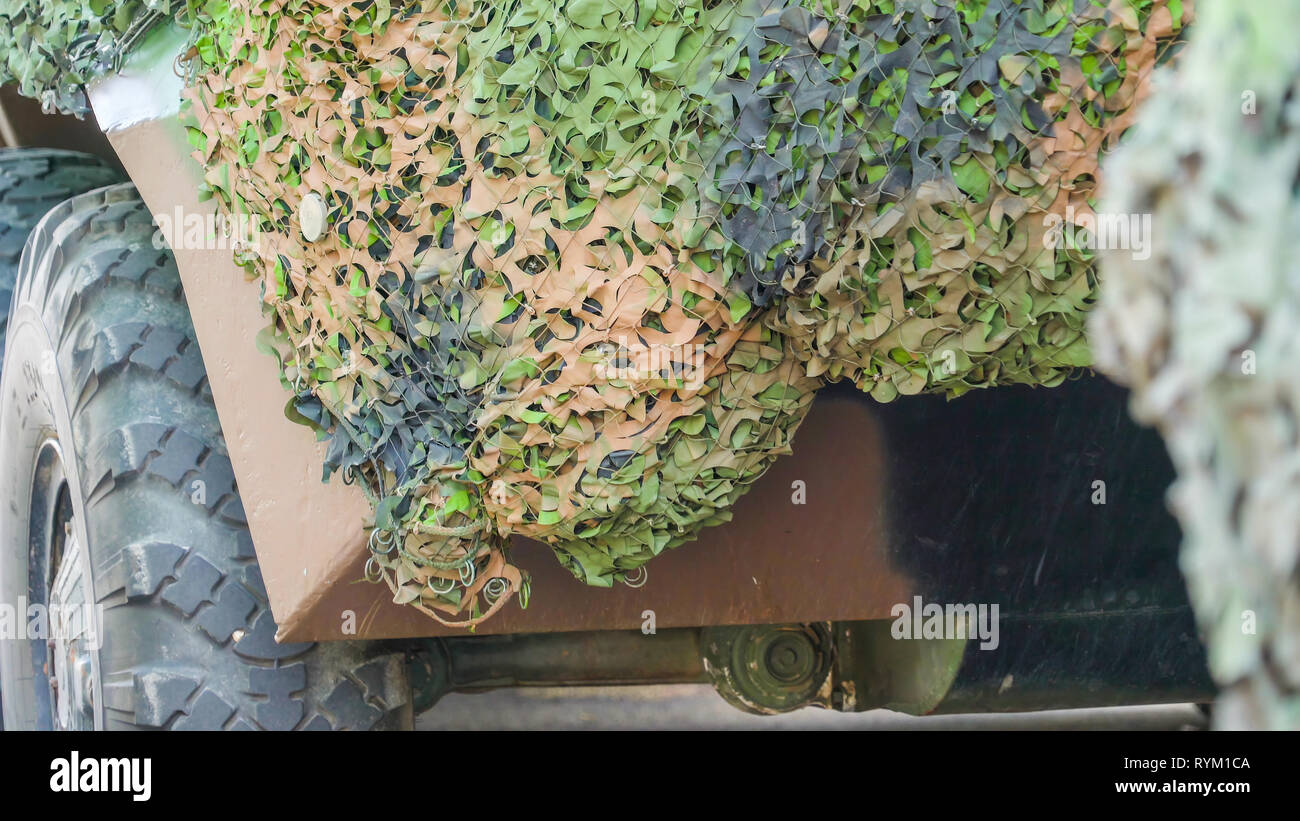 Closer look of the military tank with the camouflage cover on it to be ...