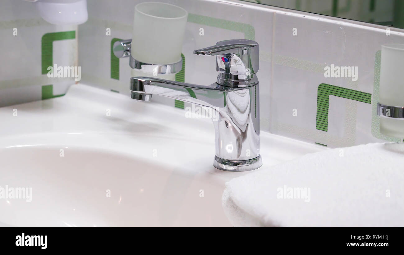 The closer look of the steel silver faucet inside the bathroom with the ...