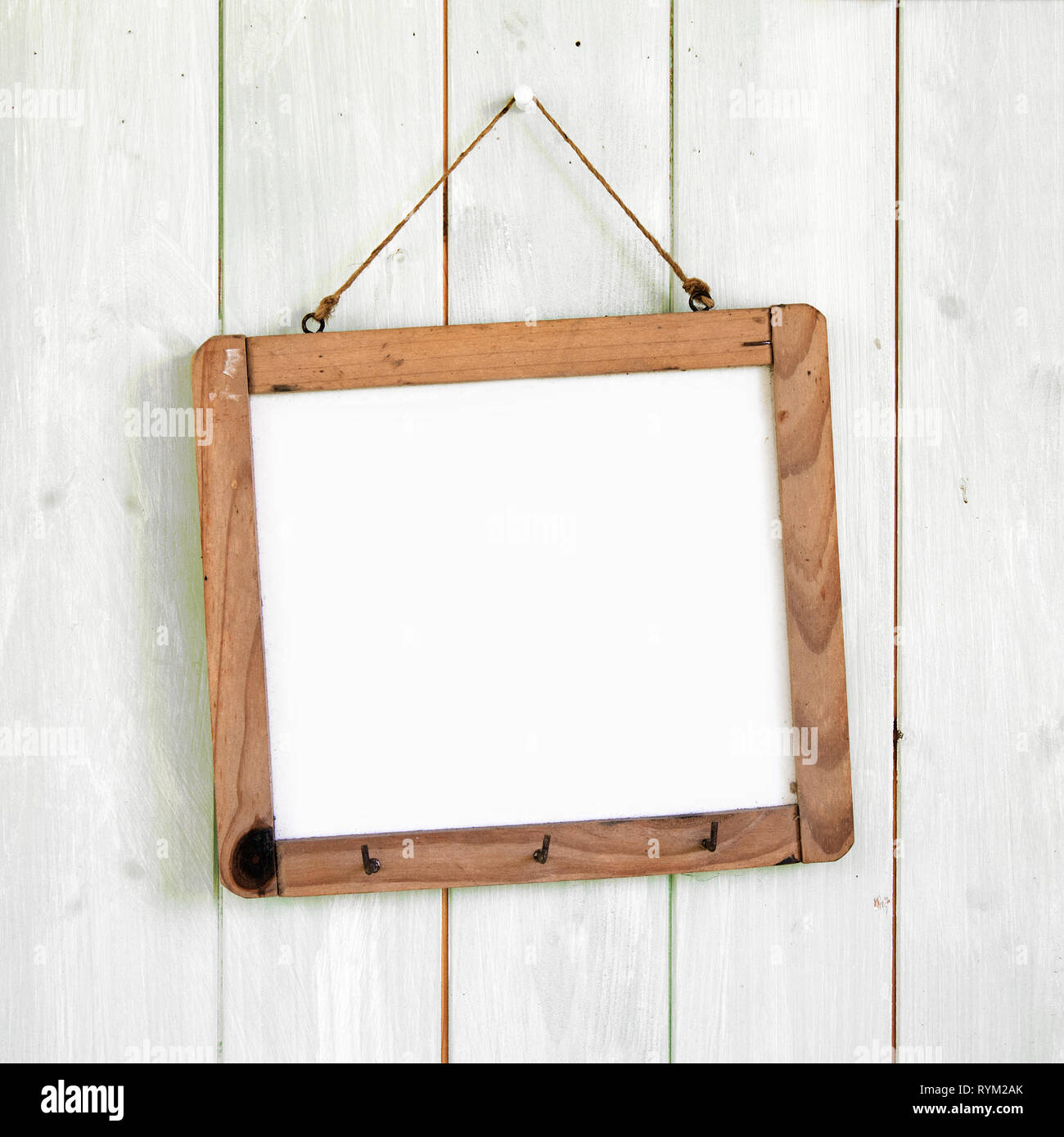 Blank message board hanging on retro white wooden wall background Stock ...