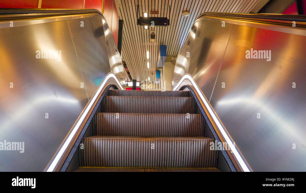 The going up escalator of the building with the railing on the side ...