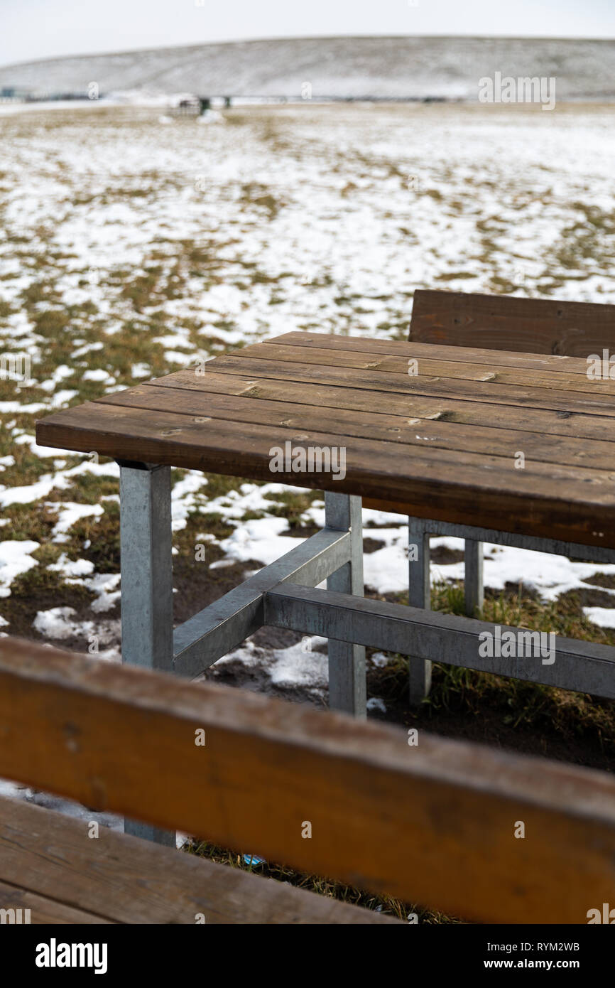 Empty wooden table with snow bokeh for a catering or food background ...