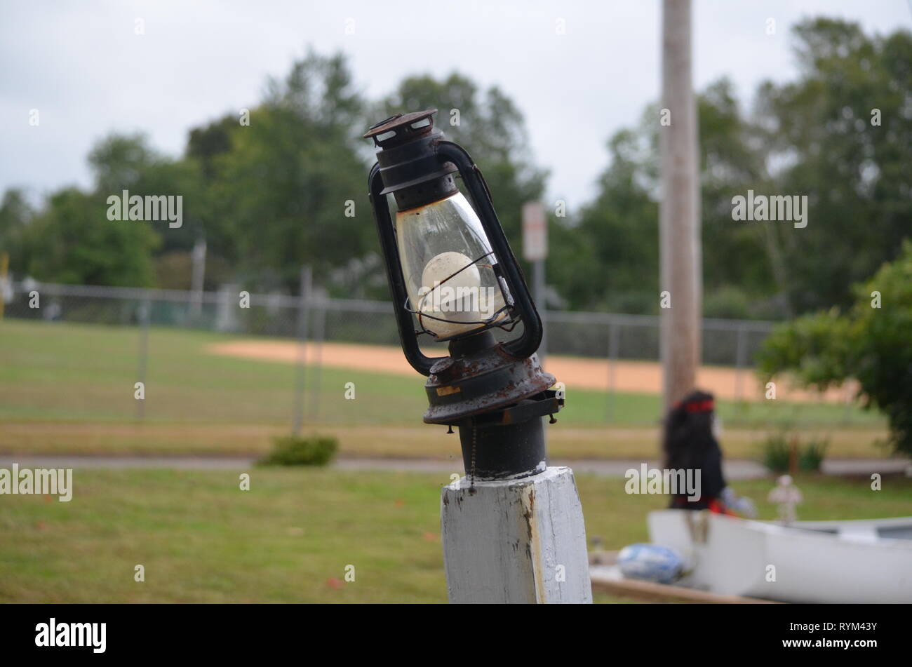 Broken lantern on a post Stock Photo - Alamy