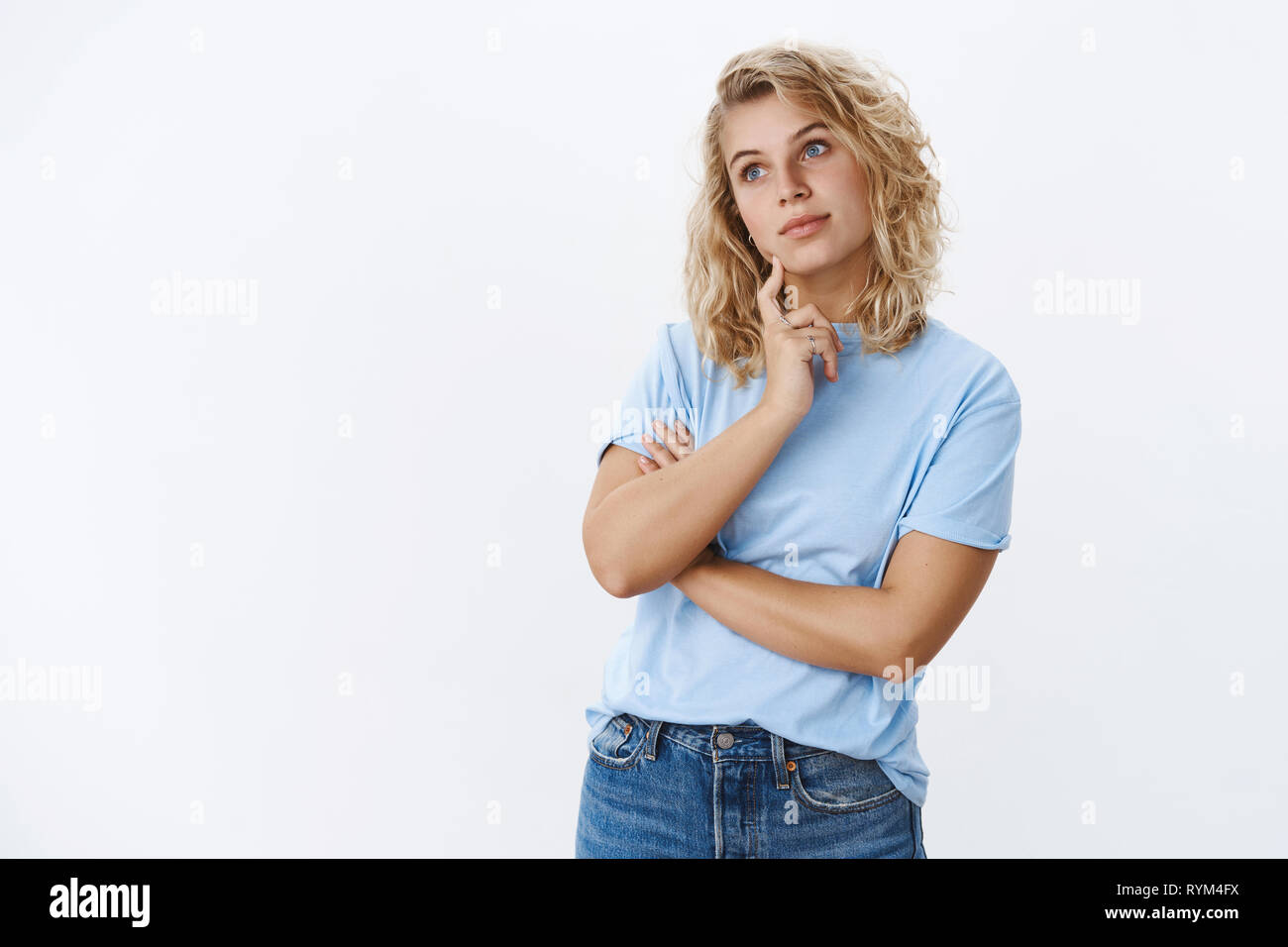 Hmm let me think. Portrait of focused attractive female friend standing ...