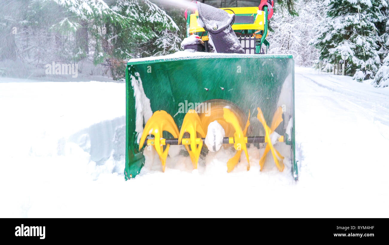 The snow plower with the sharp machine infront with the thick snow ...