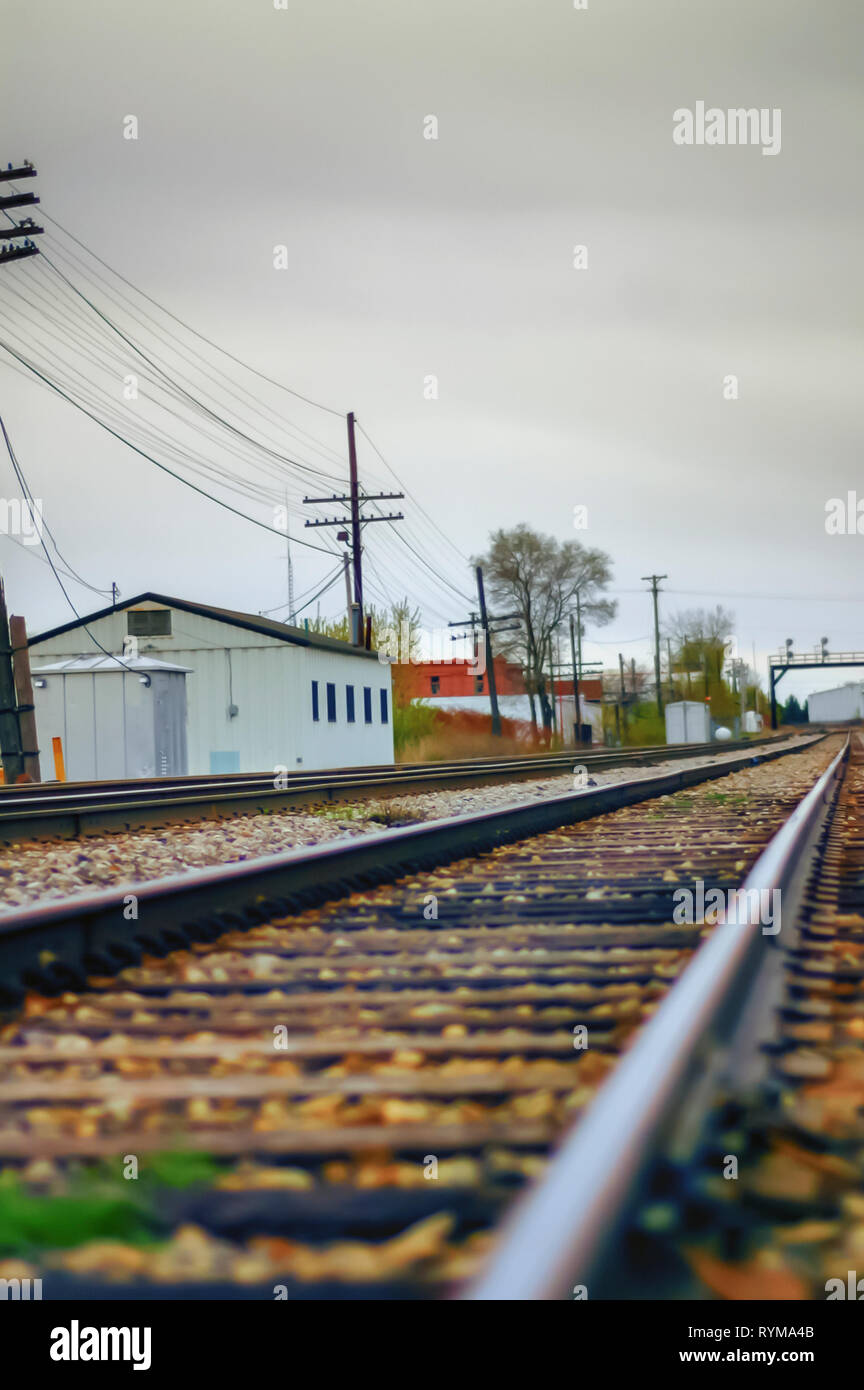 A low angle shallow depth of field shot of railway tracks disappearing ...